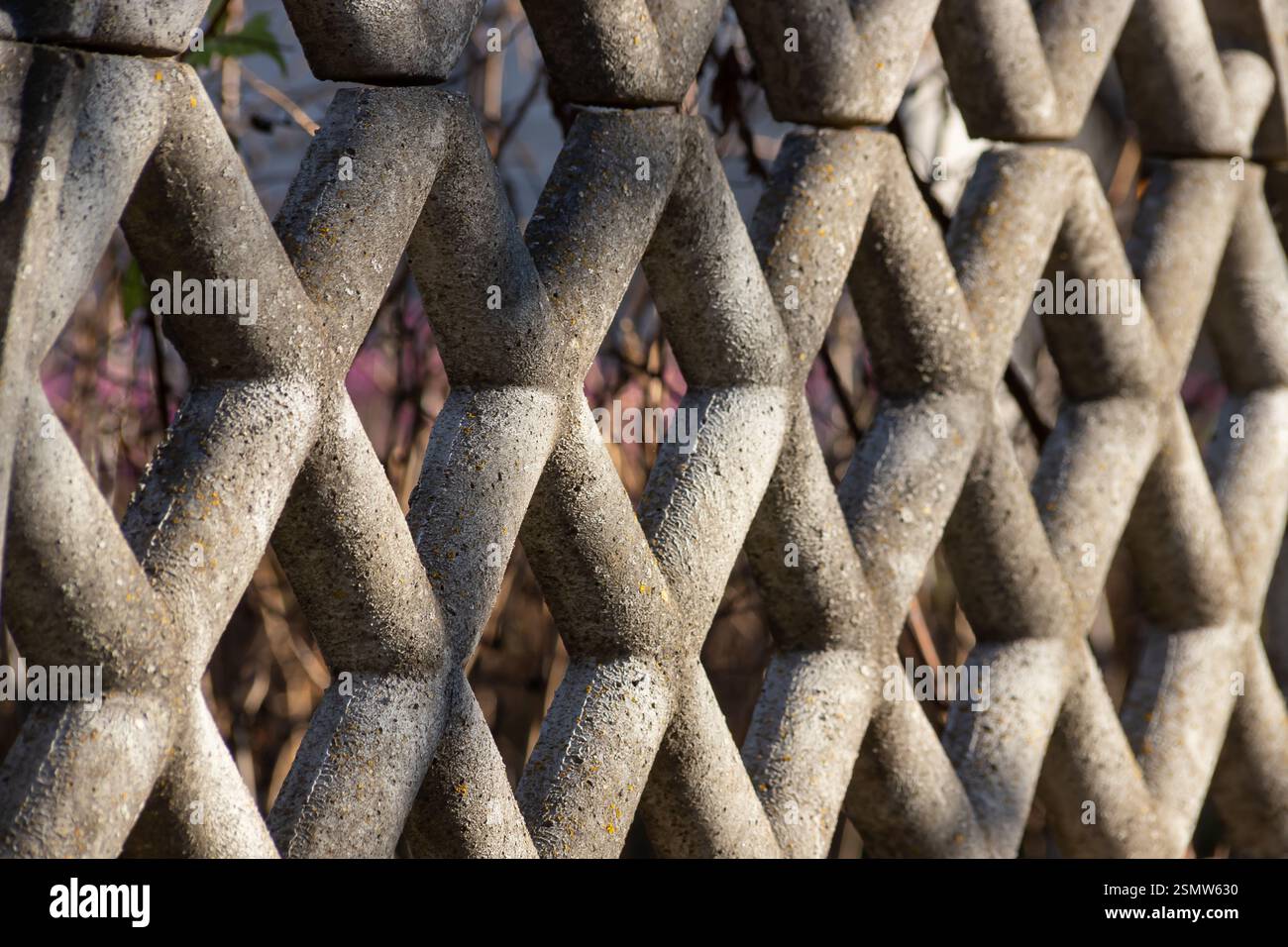 The unique hexagonal design of a concrete fence casts interesting ...