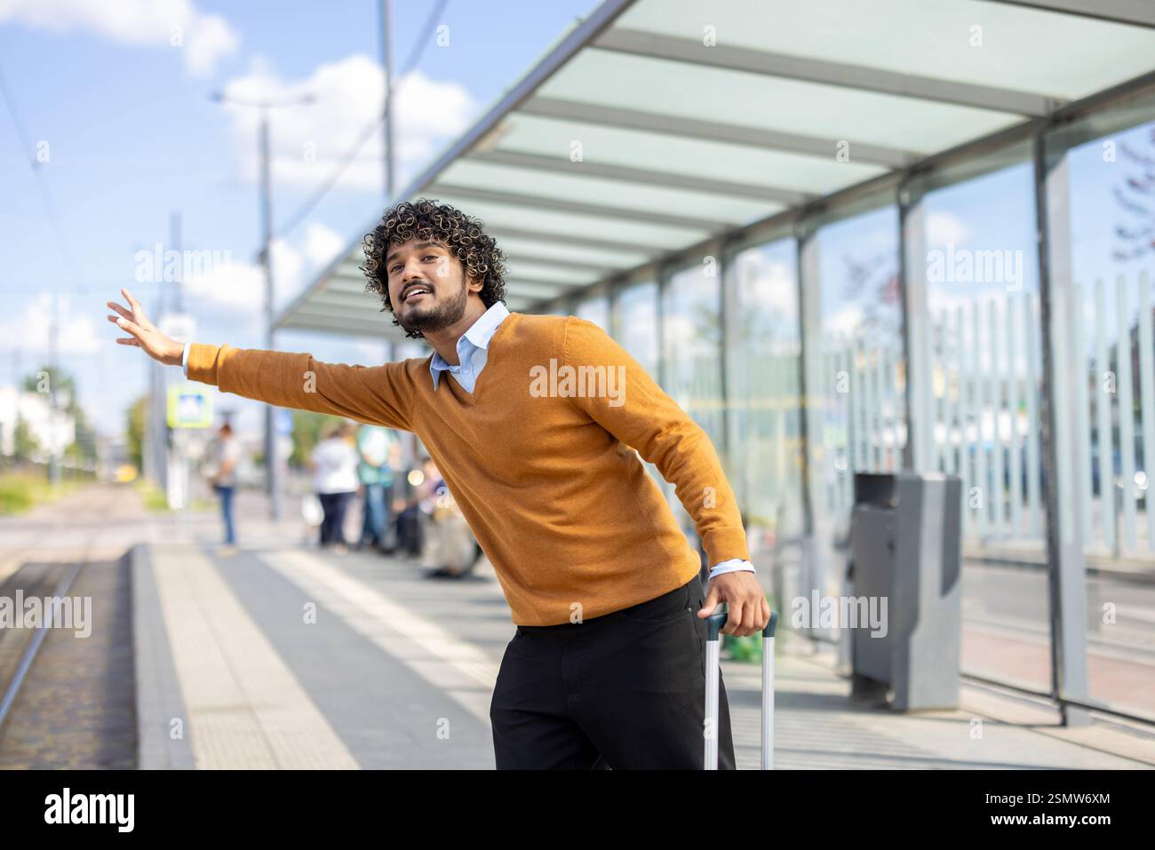 Passenger with suitcase trying to stop bus or taxi. Man standing waving ...