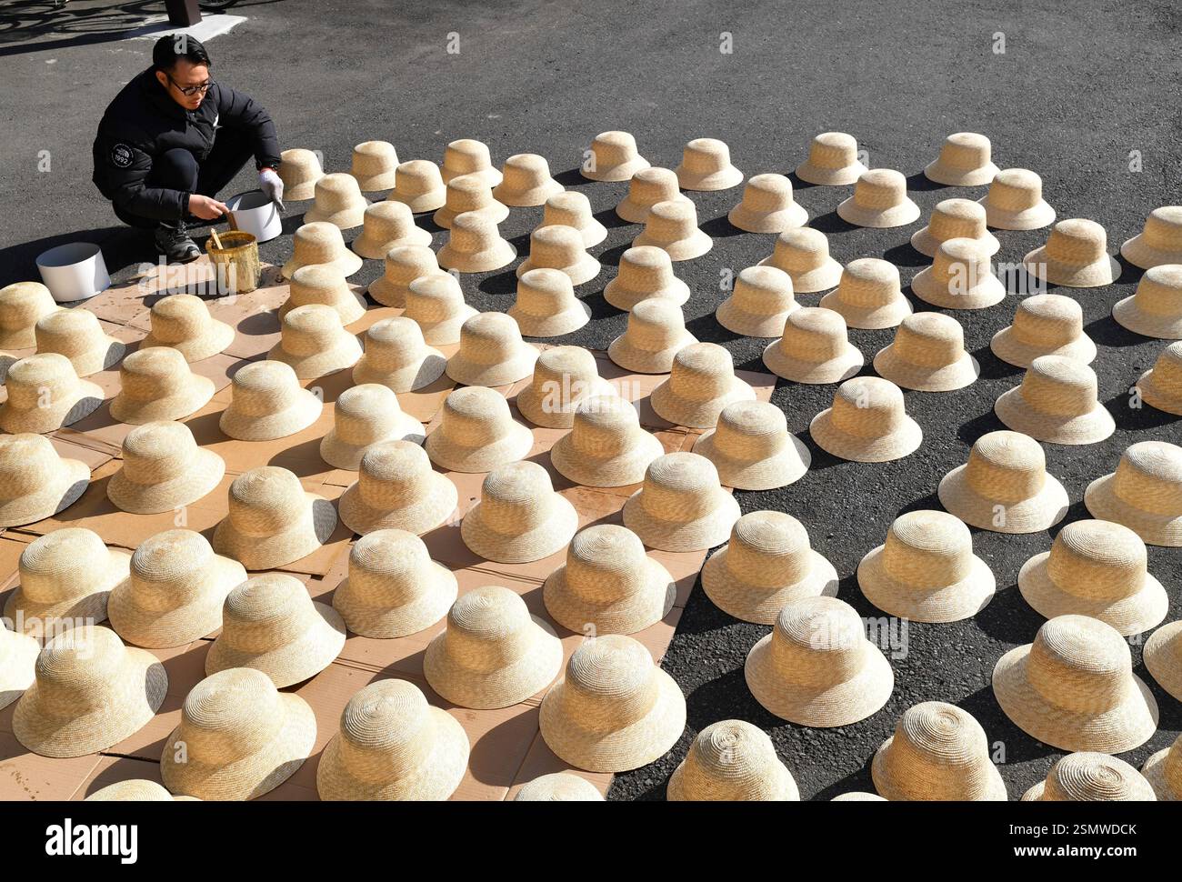 Straw hats are dried in cold air at Tanaka Hat, a company that makes ...
