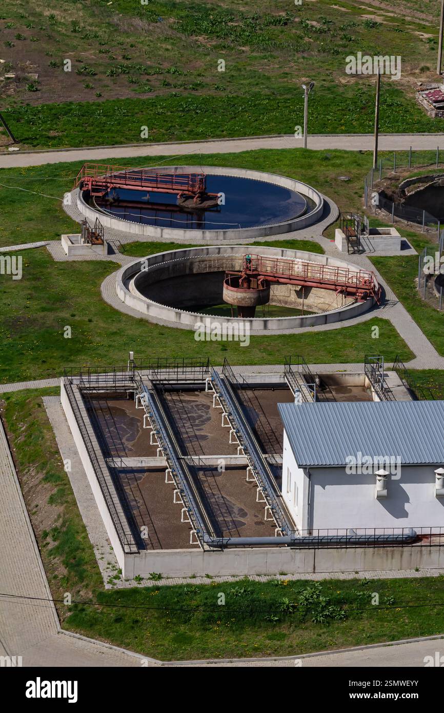 The facility features multiple circular water treatment tanks ...