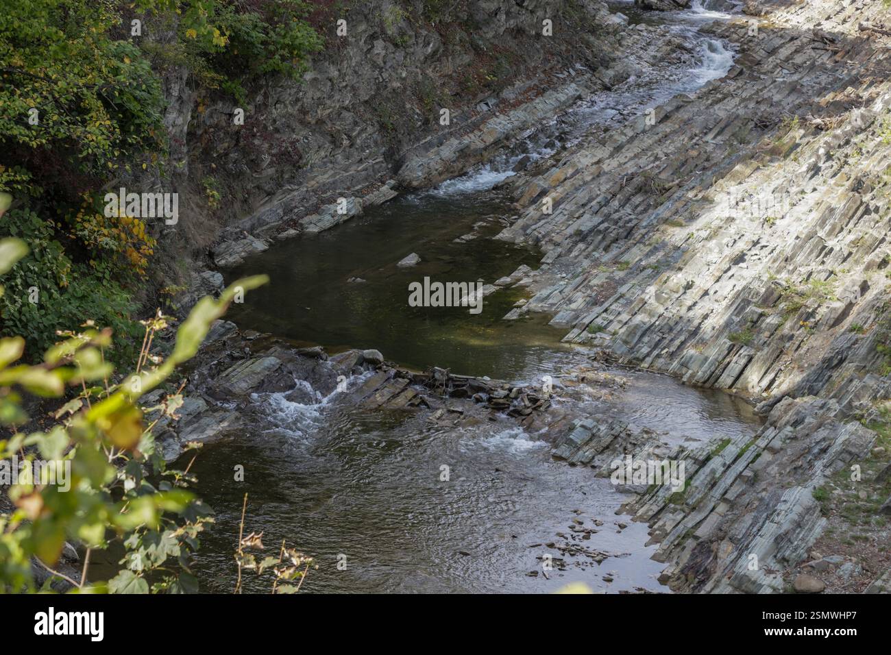 Clear waters of a river meander through stunning geological formations ...