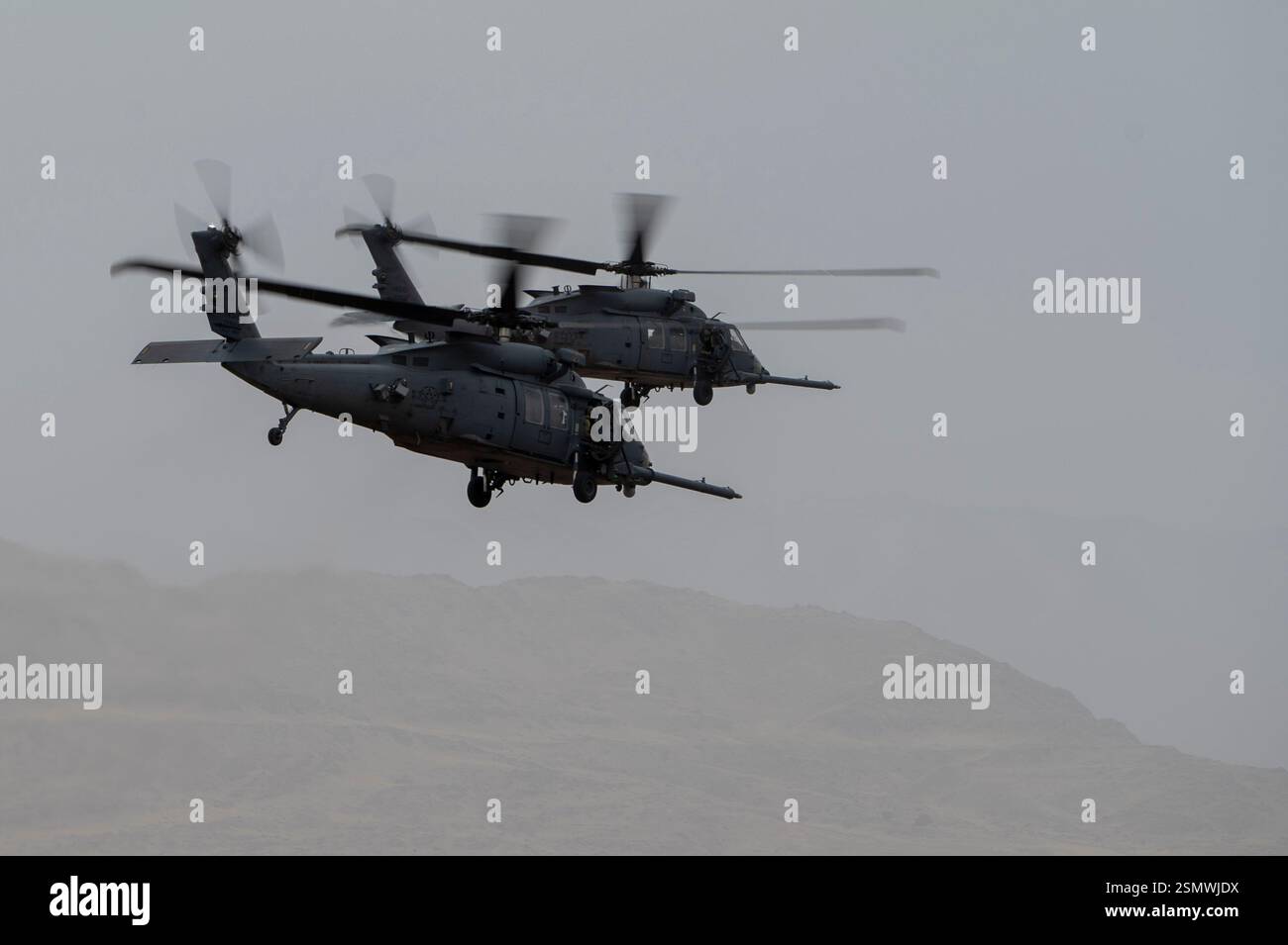 Two U.S. Air Force HH-60W Jolly Green II helicopters assigned to the ...