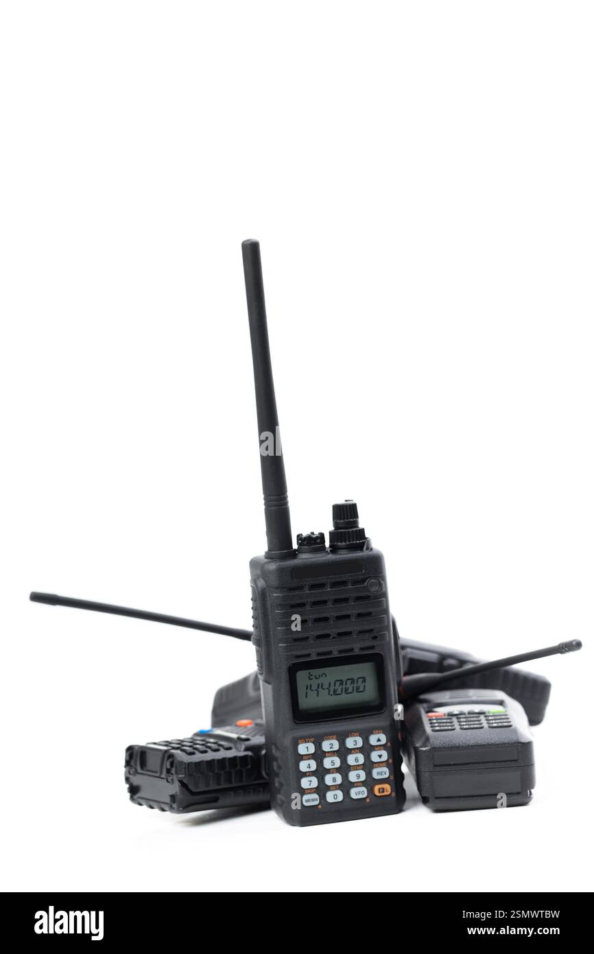 Multiple handheld radios stacked together on a white background ...