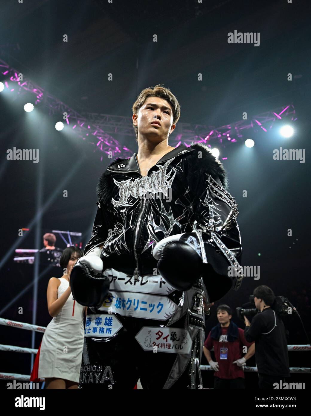Tokyo, Japan. 24th Jan, 2025. Champion Jin Sasaki (black gloves) throws a left at challenger ...