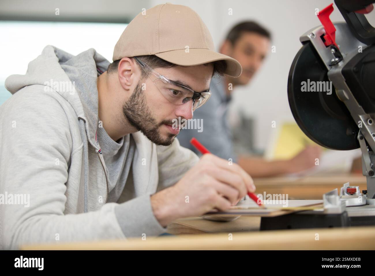 male worker making position to cut with circular saw Stock Photo - Alamy