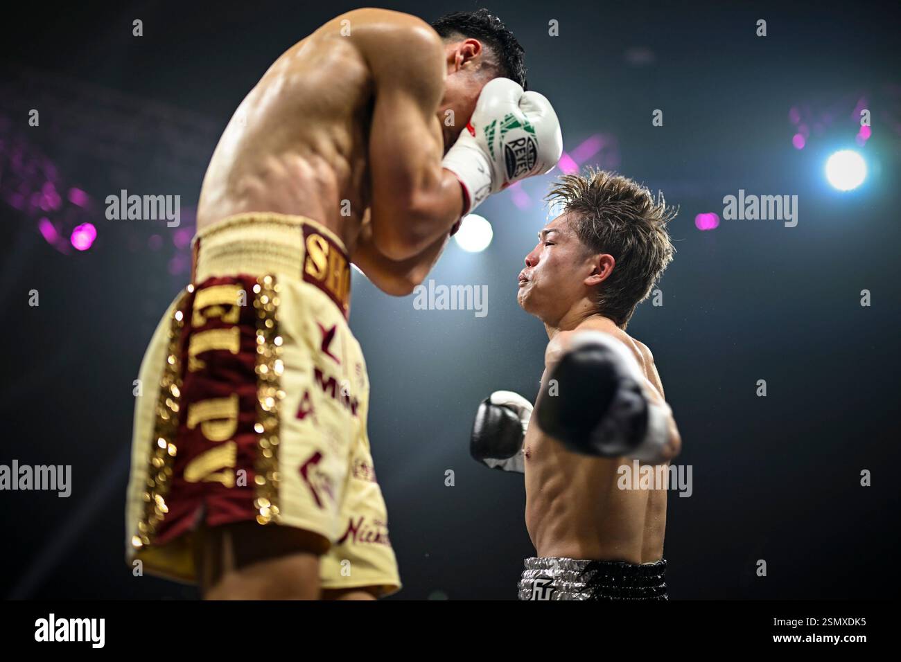 Tokyo, Japan. 24th Jan, 2025. Champion Jin Sasaki (black gloves) throws a left at challenger ...