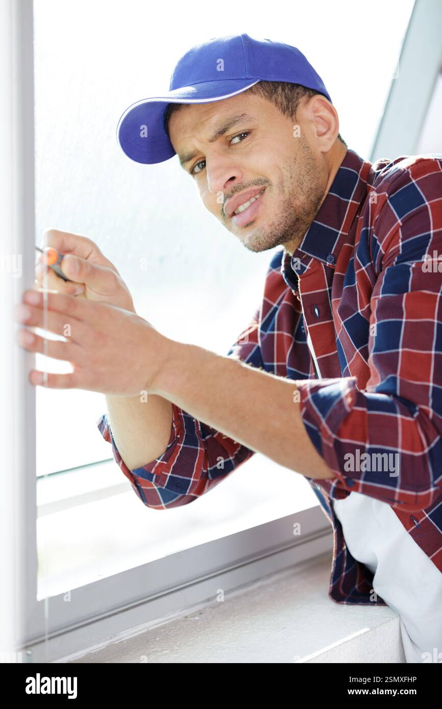 Young man installing window hi-res stock photography and images - Alamy