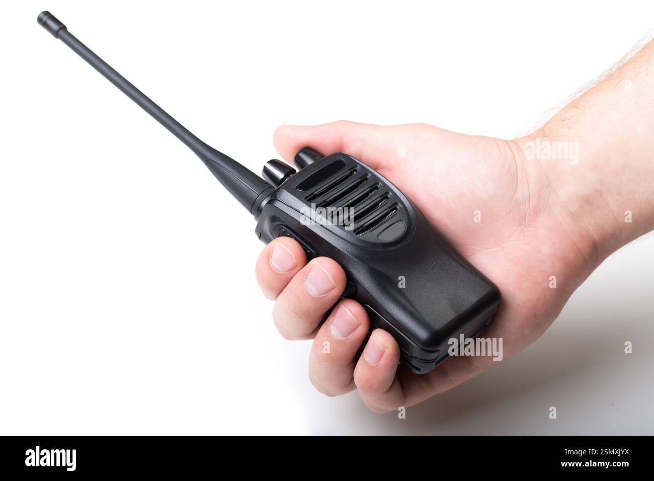 Handheld radio communication device held in a person's hand showing ...