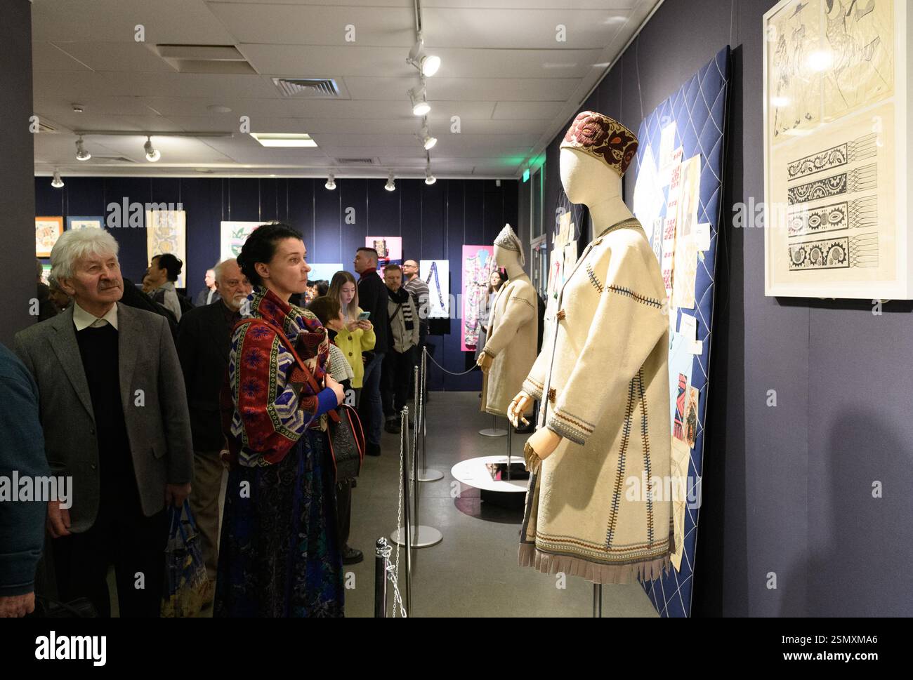 KYIV, UKRAINE - FEBRUARY 12, 2025 - People look at coats displayed at ...