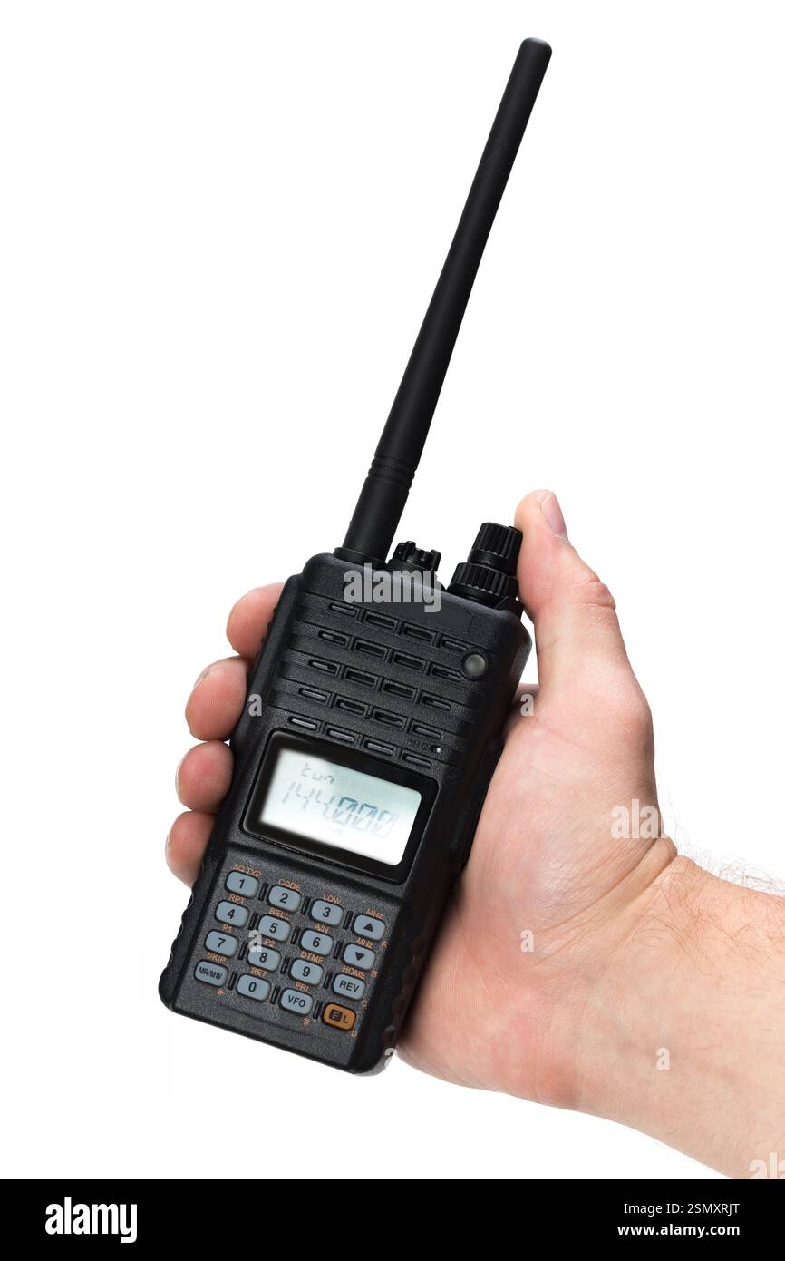 Handheld two-way radio being held in a person's hand for communication ...
