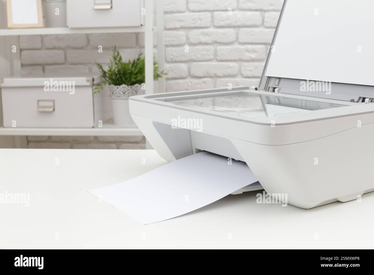 Home office setup highlights multifunction printer printing document in ...