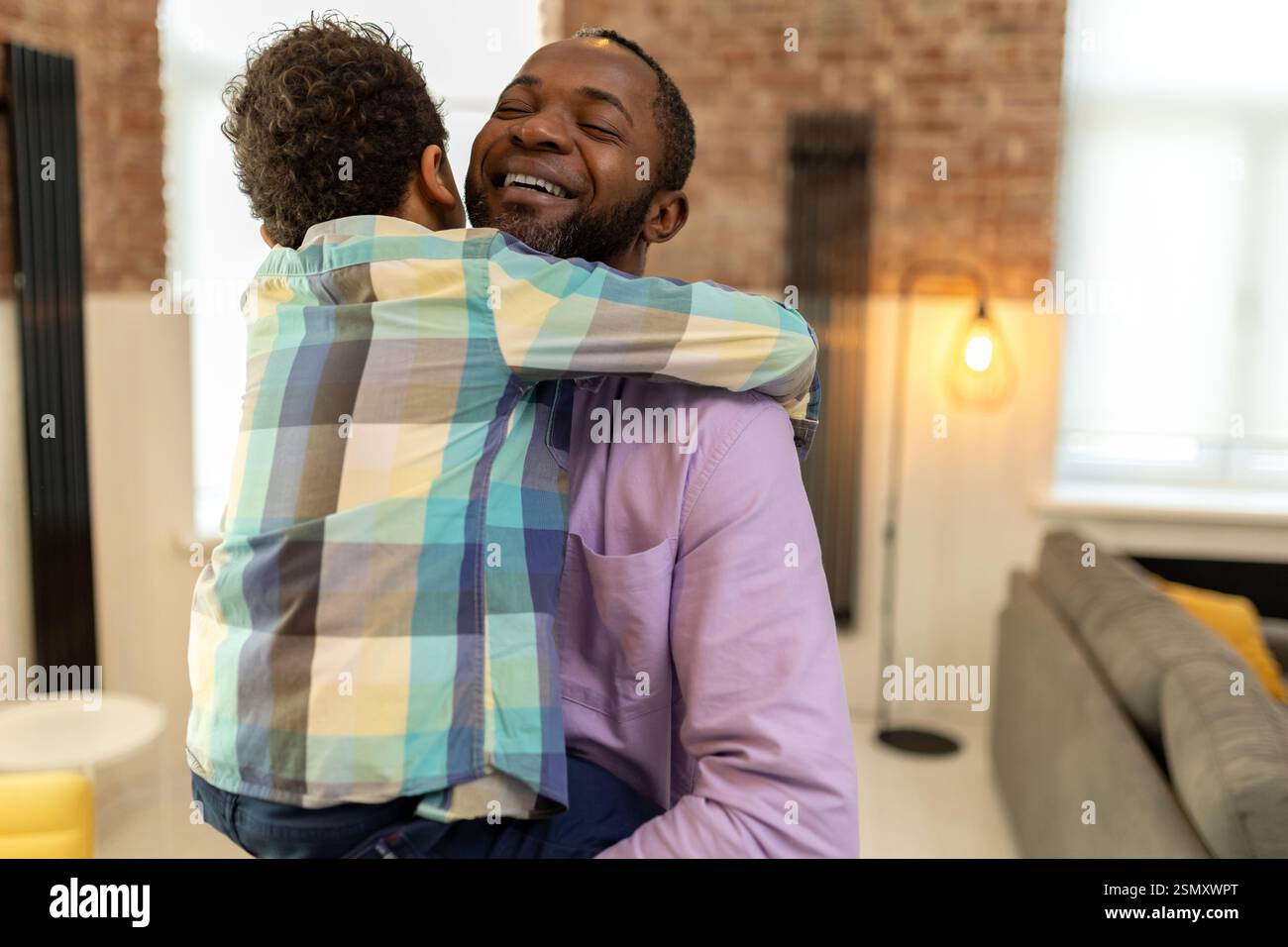 Dad and son hugging and looking happy and enjoyed Stock Photo - Alamy