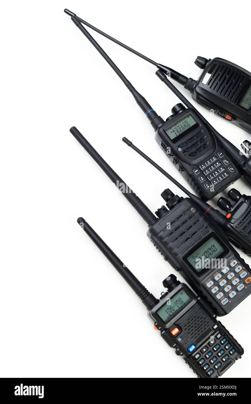 Multiple handheld radios arranged in a row displaying various features ...