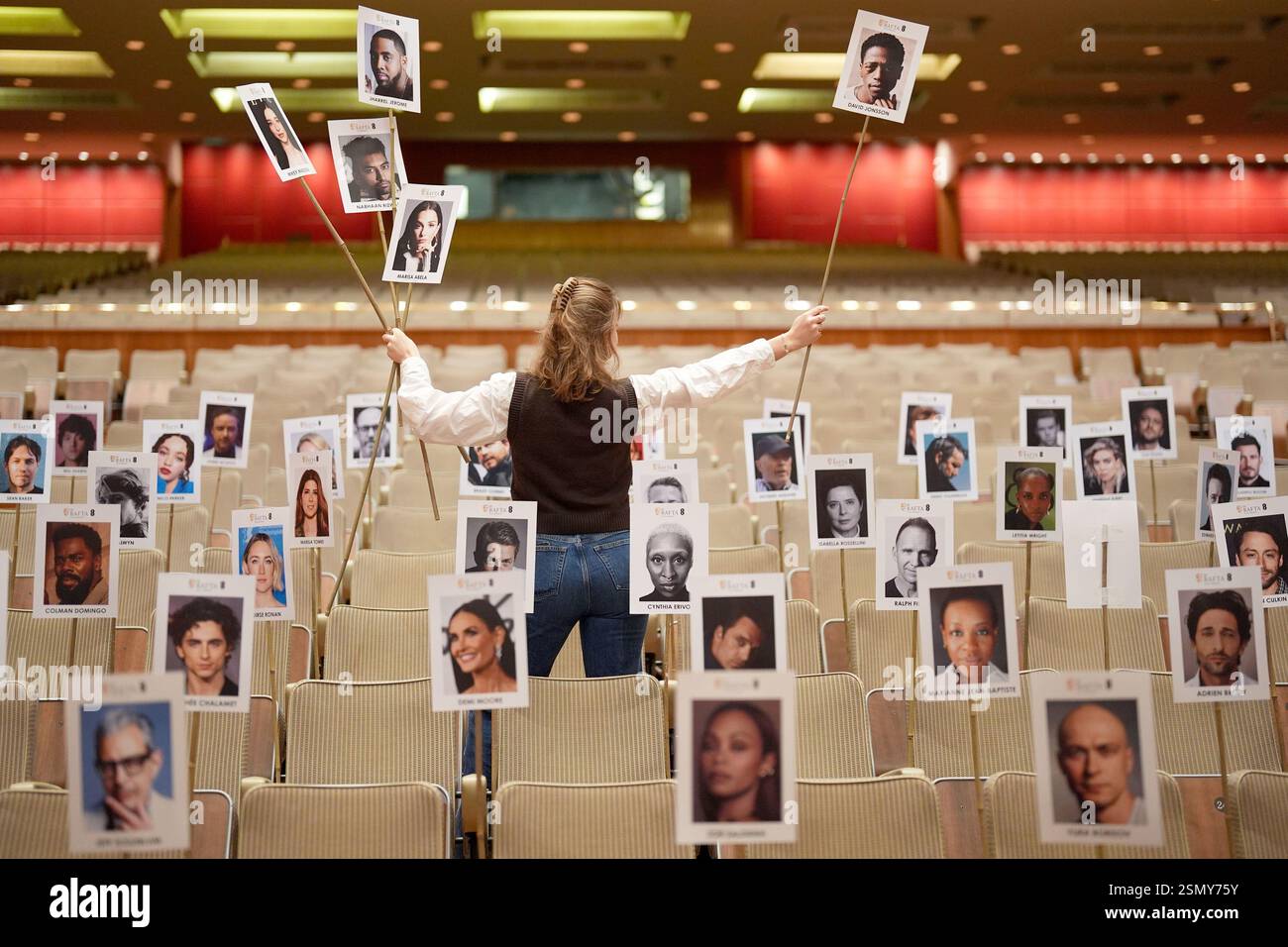 A staff member uses "heads on sticks" to check camera blocking at the ...