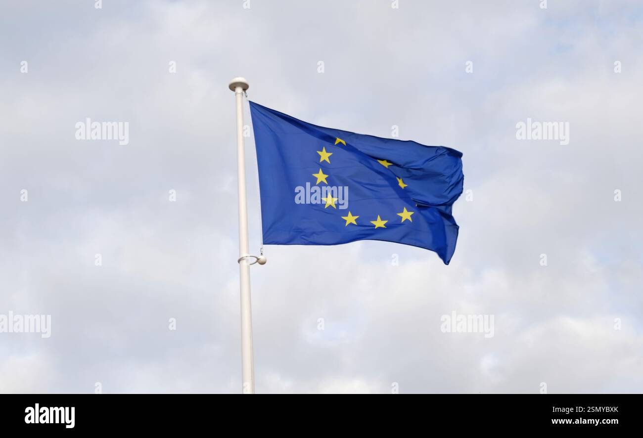 Flag of the European Union waving in the wind on flagpole against the ...
