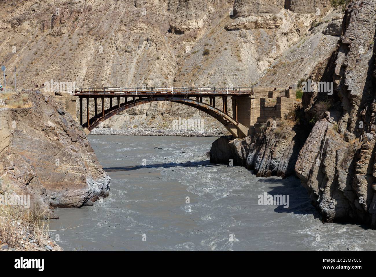 A tranquil view of a bridge spanning the Zarafshon River against a ...