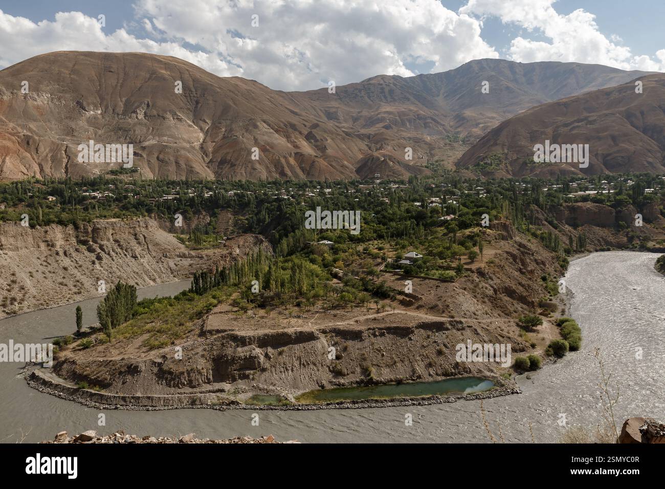 Zarafshon river winds through Zerobod village, surrounded by mountains ...