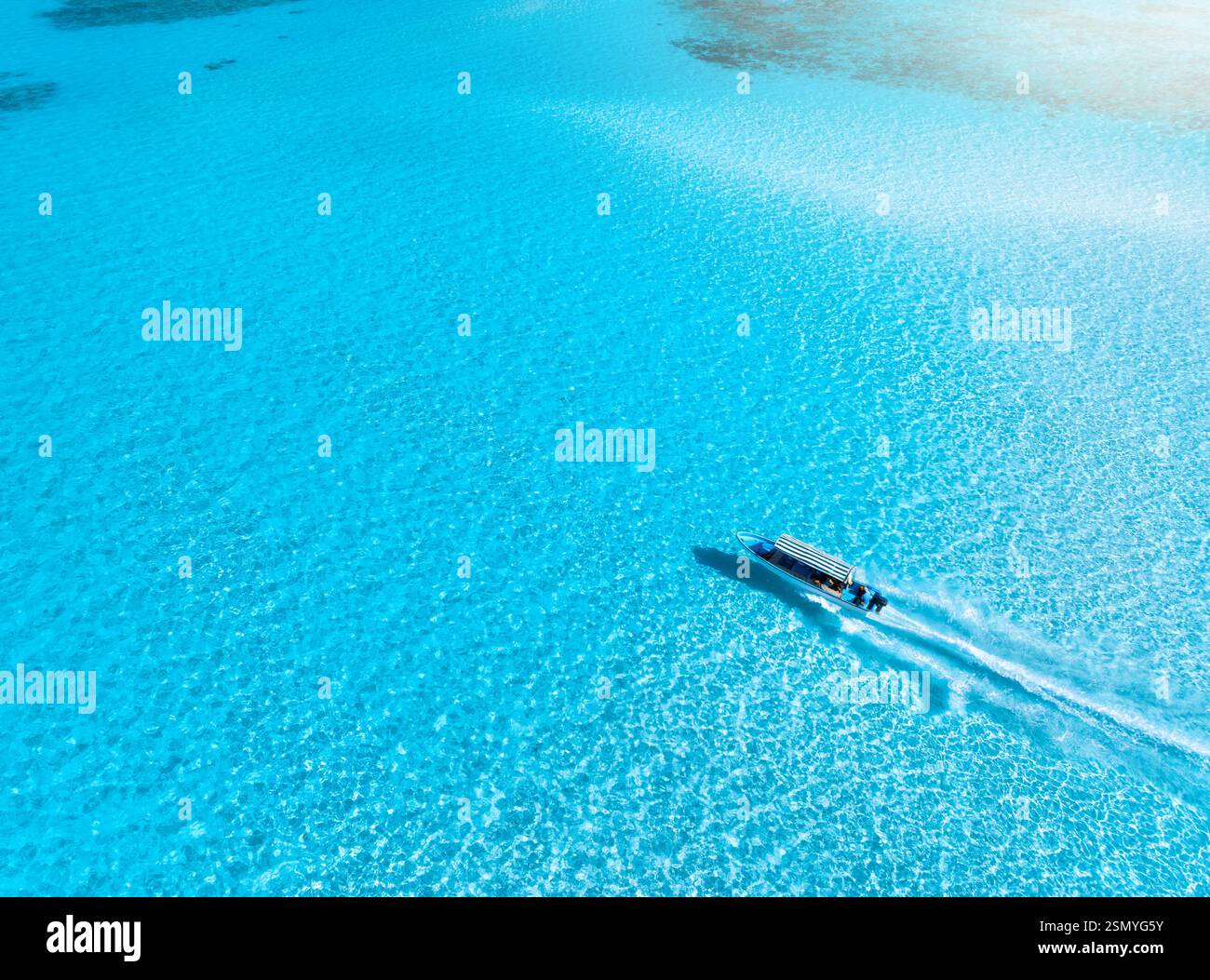 Aerial view of floating boat in clear azure sea in summer Stock Photo ...