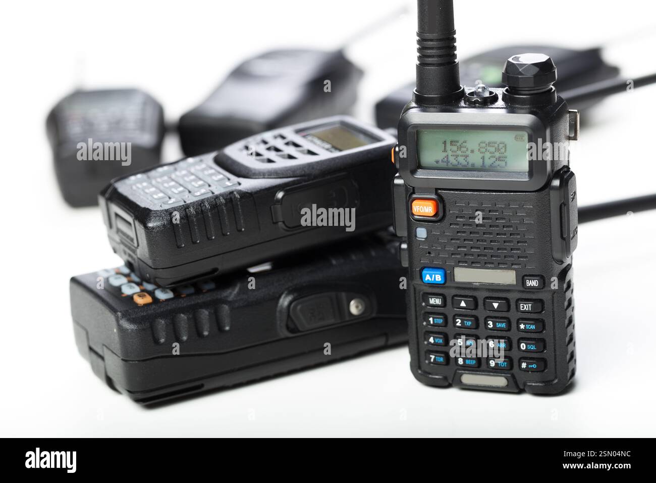 Various models of handheld radios stacked together for communication ...