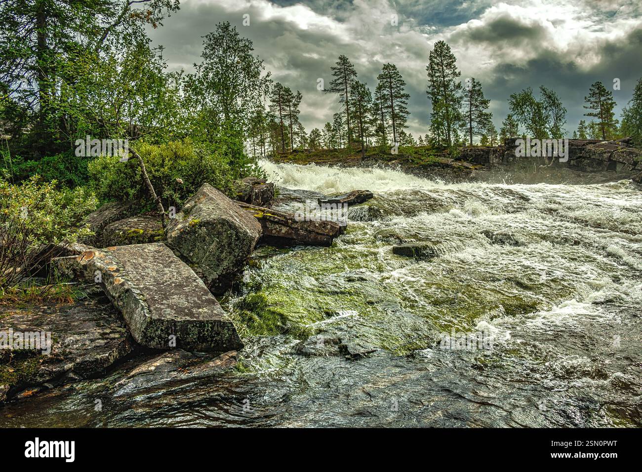 White water flowing over rocks in the Lillebekken River, surrounded by ...