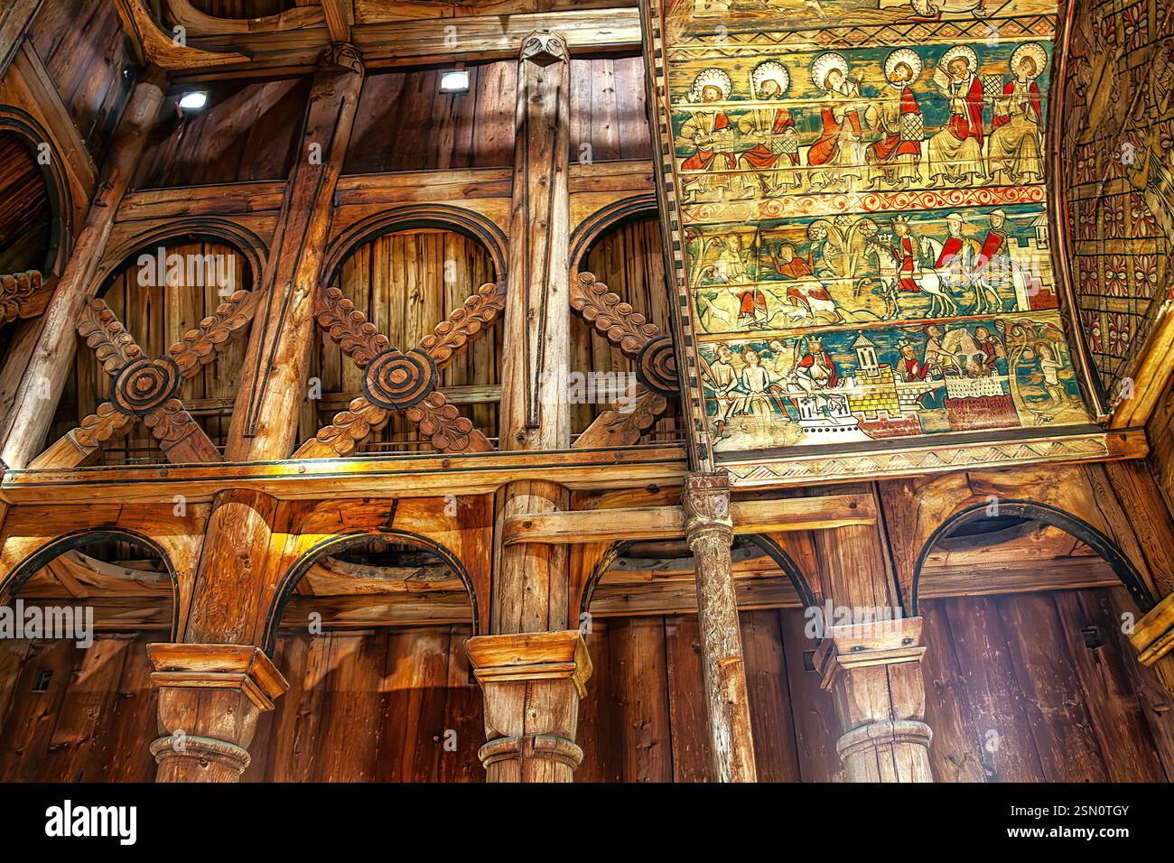 Sunlight illuminates the interior of an ancient Norwegian stave church ...
