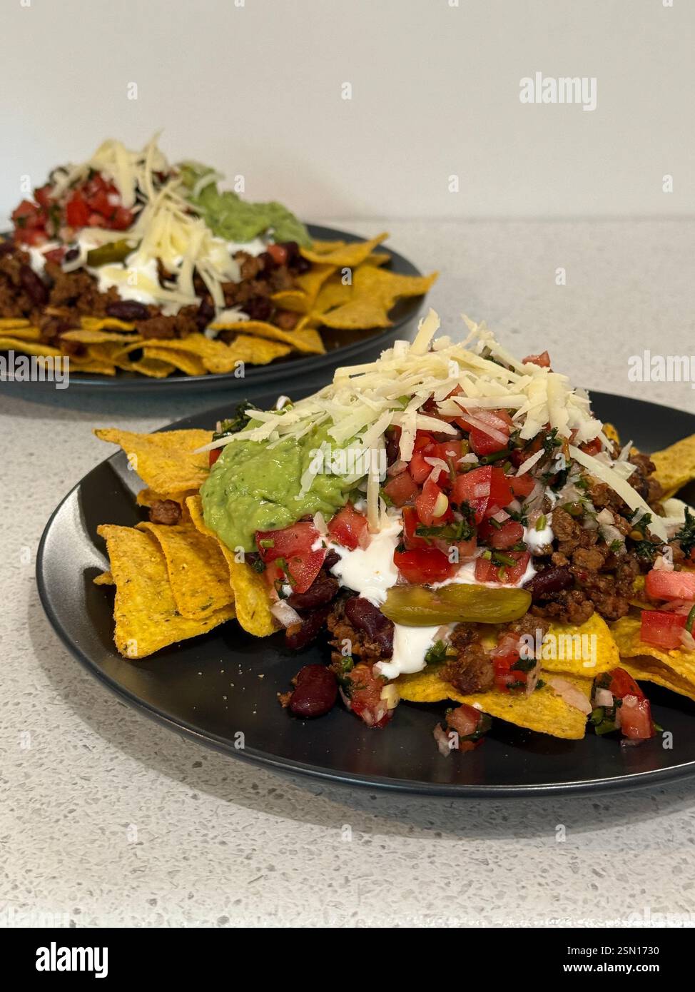 Beef nachos with multiple toppings Stock Photo - Alamy