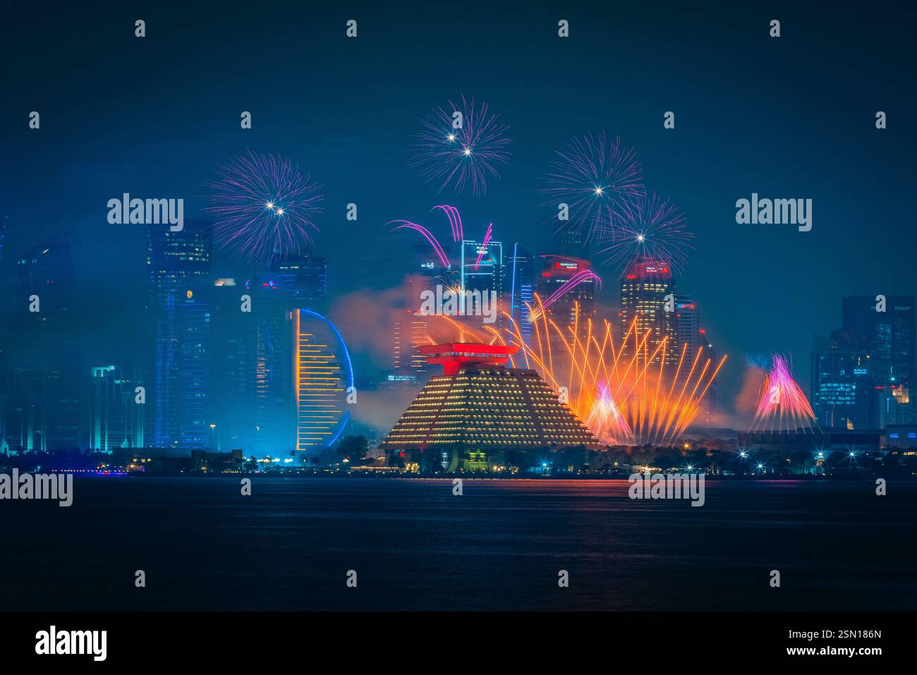 The illuminated urban skyline of Doha Qatar with fireworks for a ...