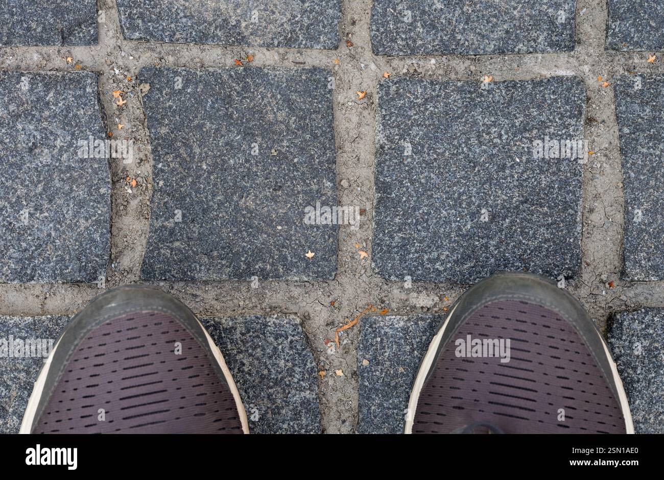 Black running shoes standing on gray granite blocks background. Focus ...
