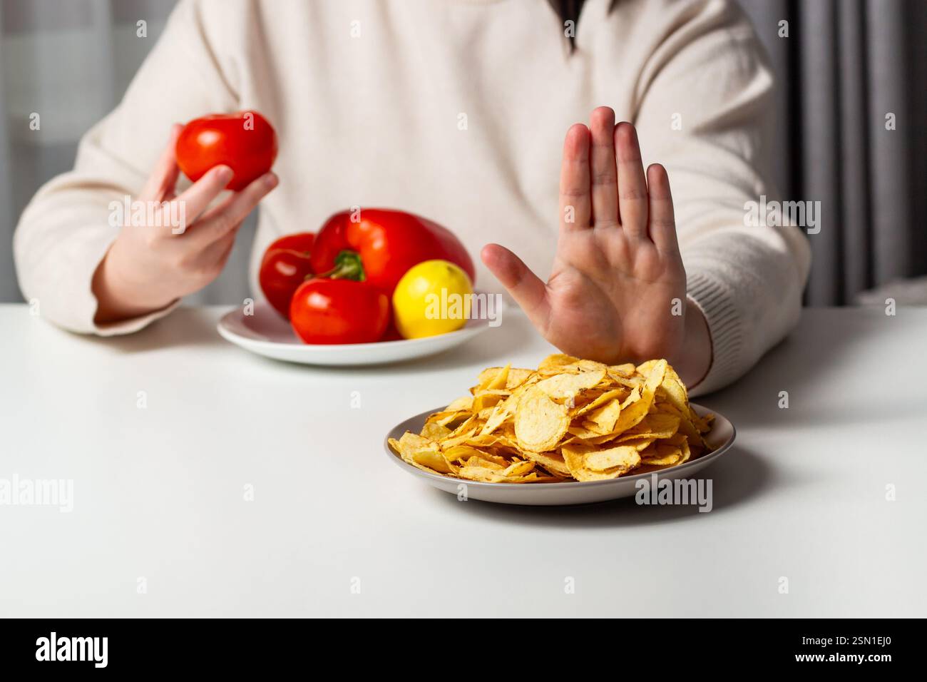 Closeup of woman making stop sign to refuse fried chips for dieting and ...