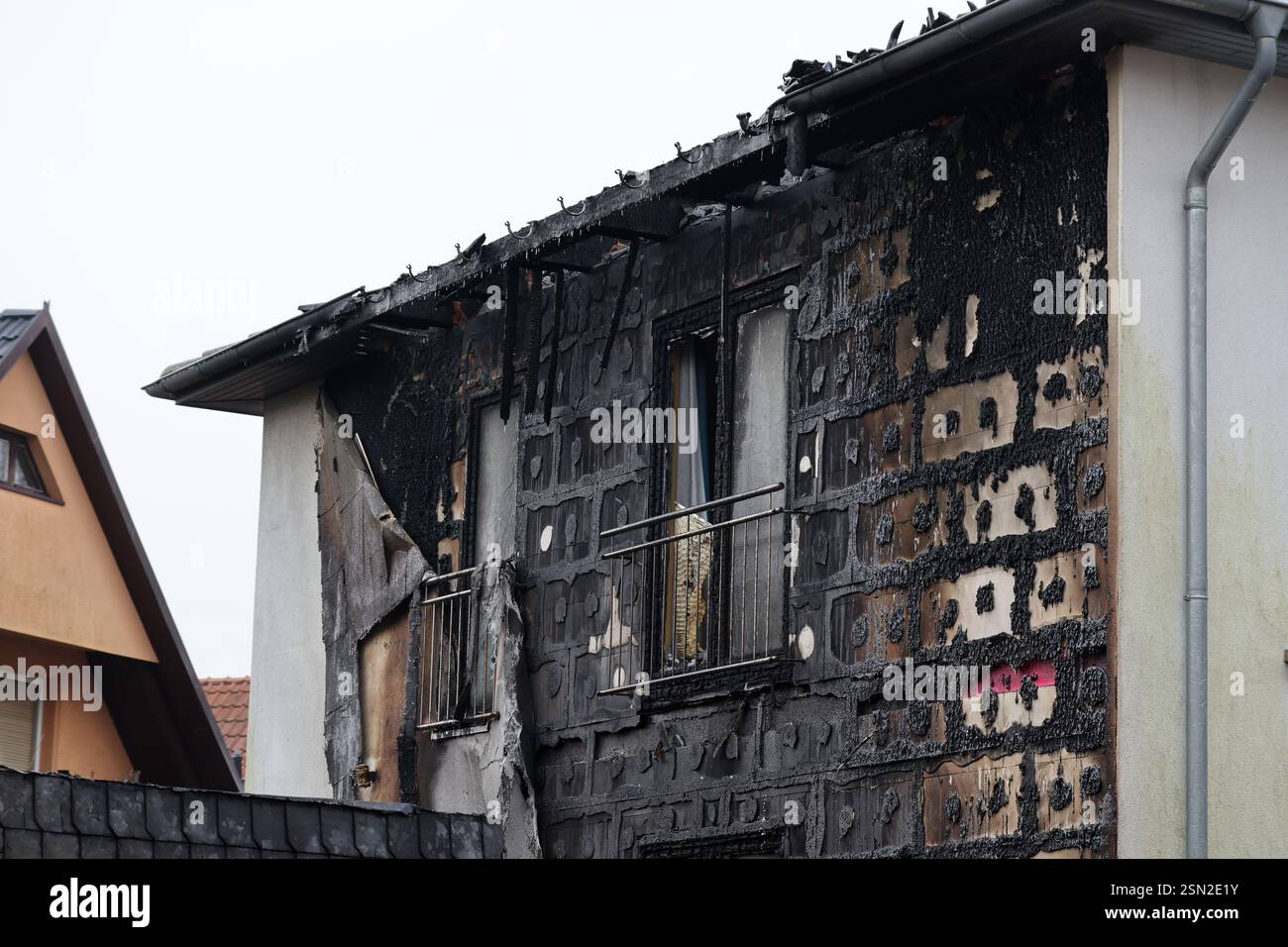Rostock, Germany. 13th Feb, 2025. The badly damaged house that caught ...