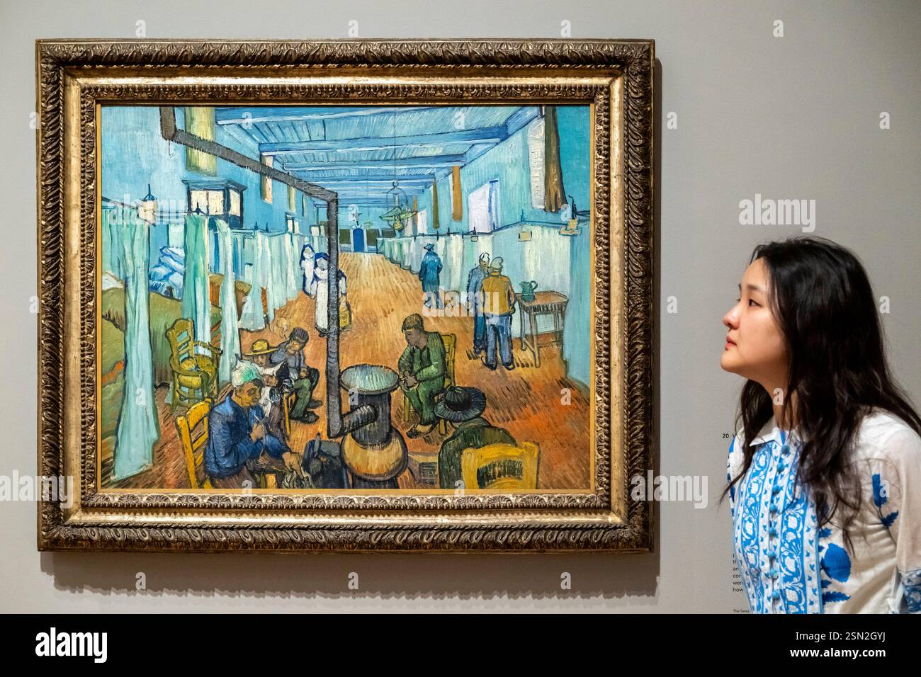 London, UK. 13 February 2025. A staff member with ‘A Ward in the Hospital at Arles’, 1889, by ...