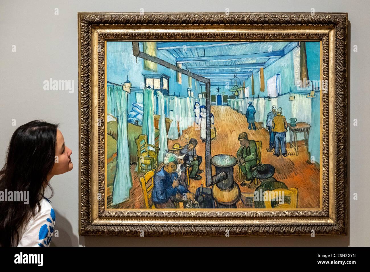 London, UK. 13 February 2025. A staff member with ‘A Ward in the Hospital at Arles’, 1889, by ...