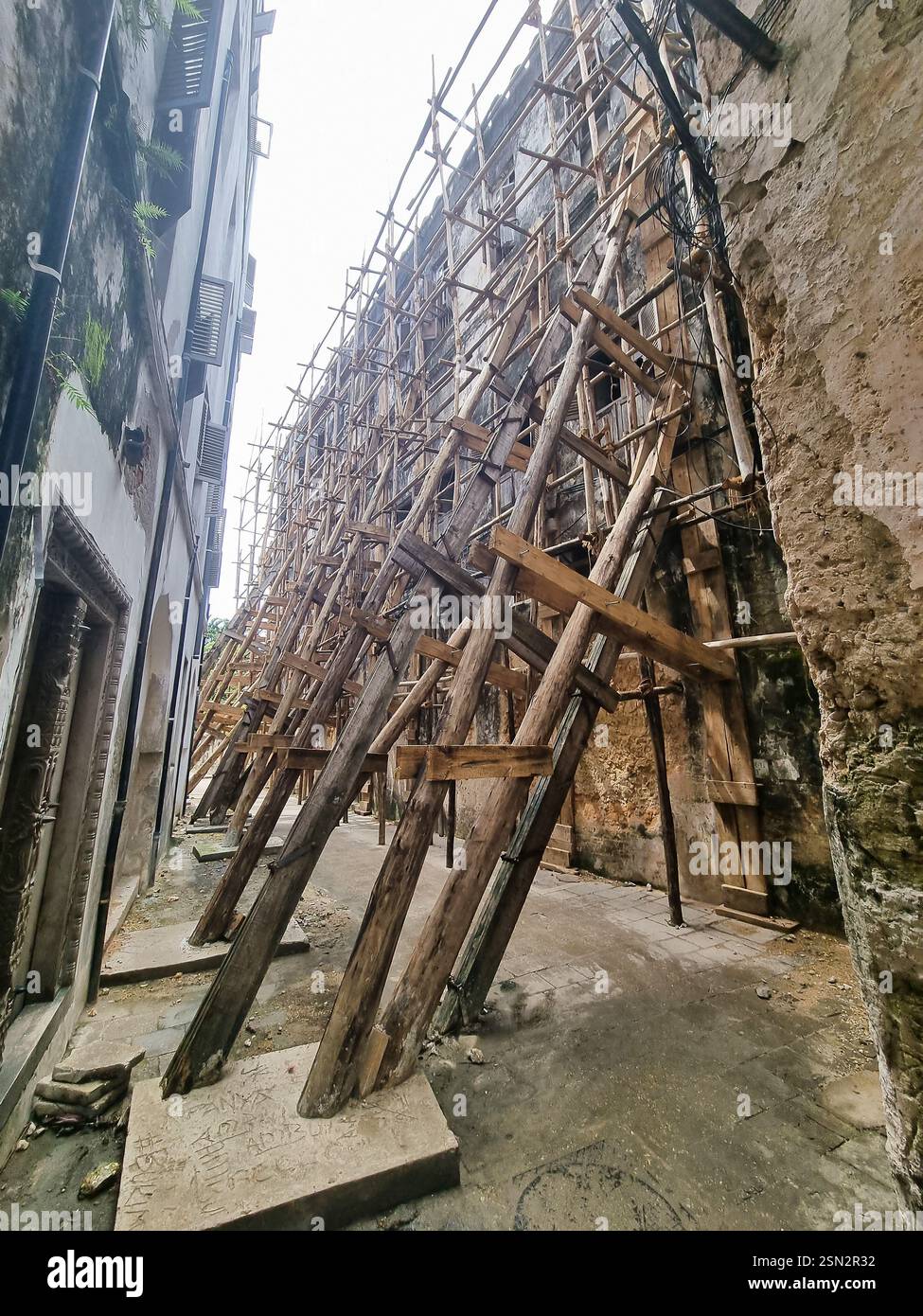 Sturdy wooden scaffolding set up prominently in an urban alley ...