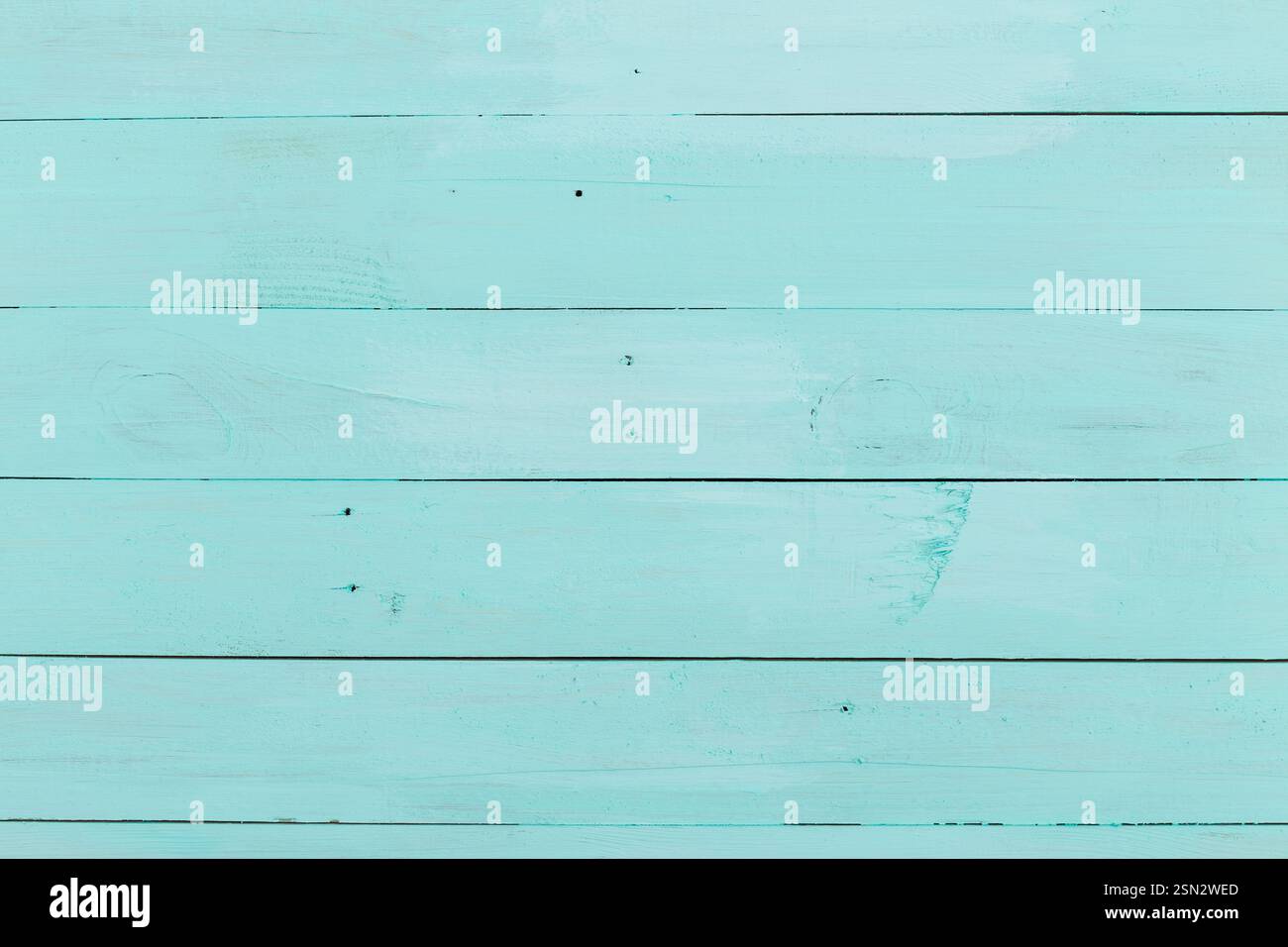 Vibrant turquoise wooden surface with visible grain patterns and slight ...