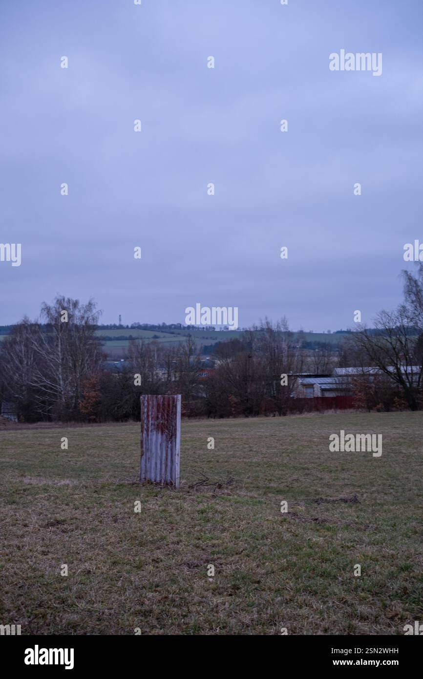 Rusty Metal Sheet in an Open Field with Distant Hills Stock Photo - Alamy