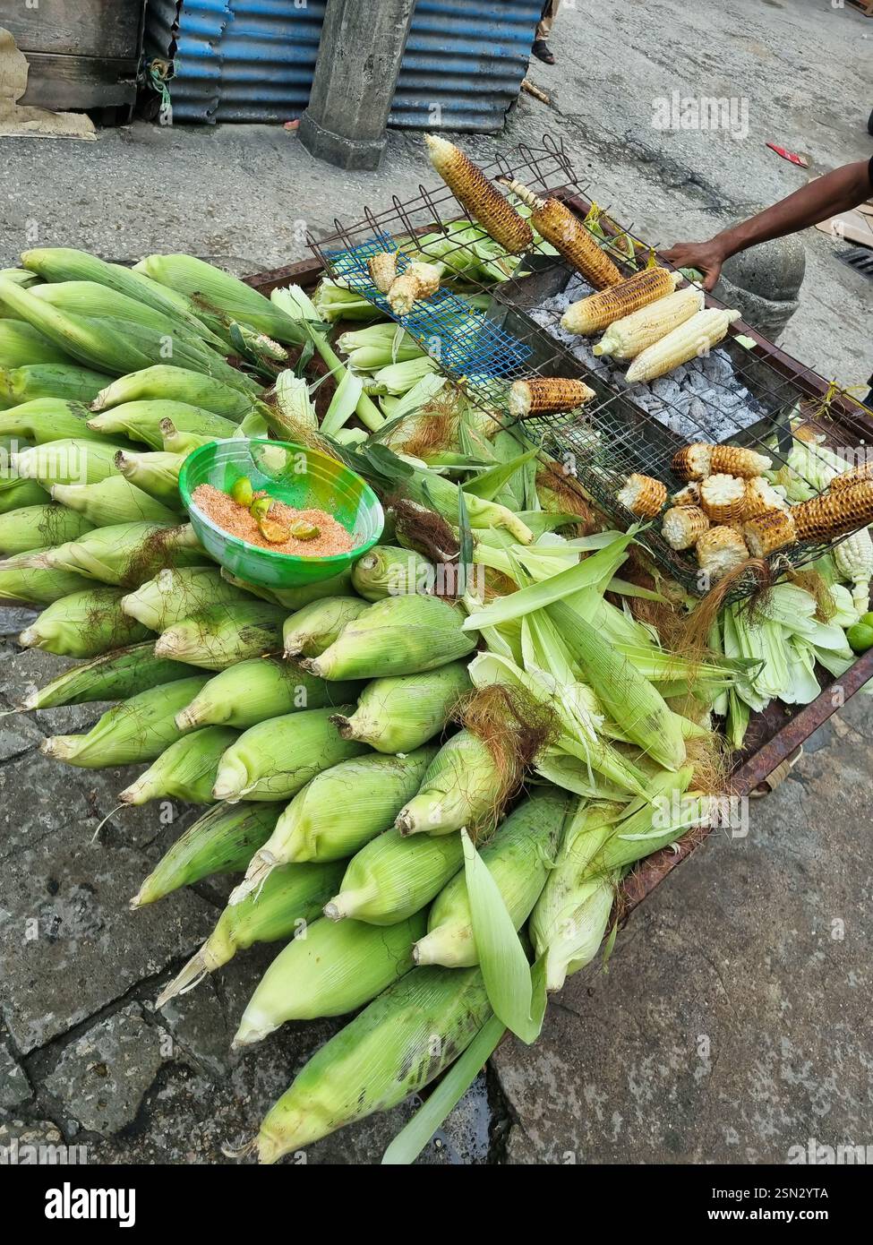 A street vendors cart features grilled corn, highlighting fresh produce ...