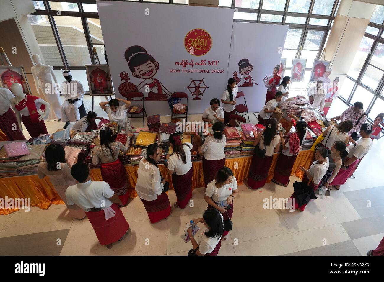 Ethnic Mon people buy their traditional clothes during a ceremony to ...