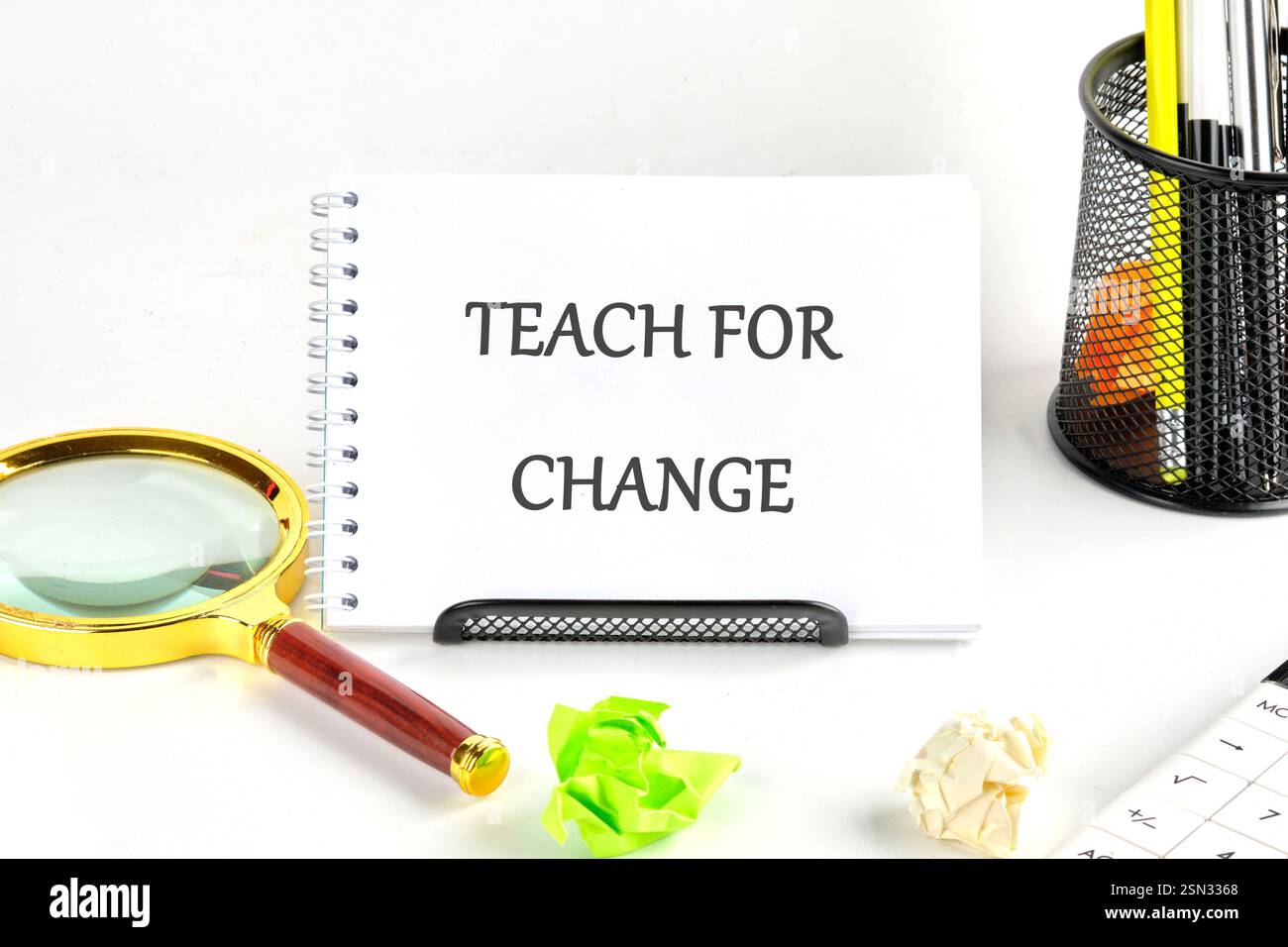 A notepad displays the phrase Teach For Change, highlighting ...