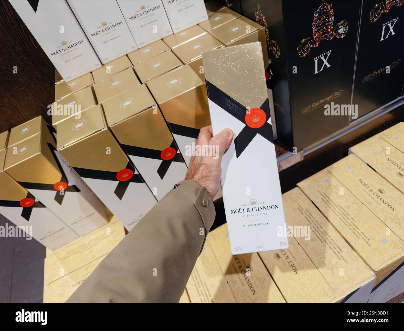 Paris, France - Dec 30, 2024: A hand holding a Moet and Chandon Brut ...