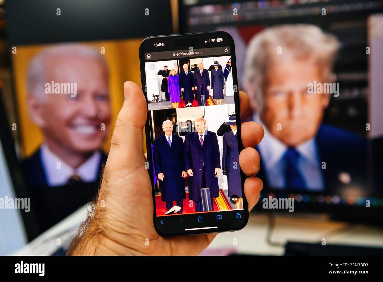 Paris, France - Jan 20, 2025: AA hand holds a smartphone showing images of Joe Biden, Donald ...