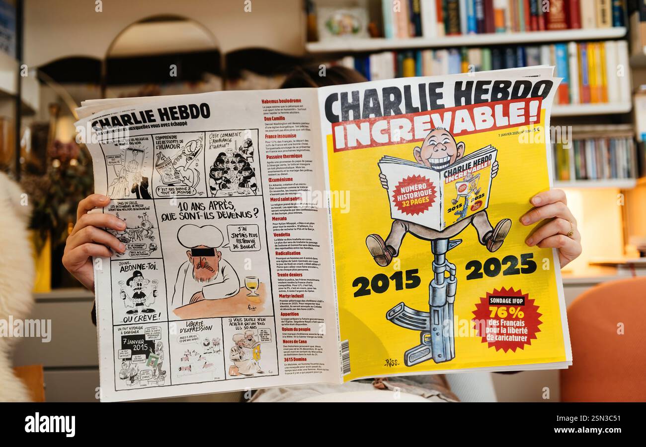 Paris, France - Jan 21, 2025: A person holding a Charlie Hebdo ...