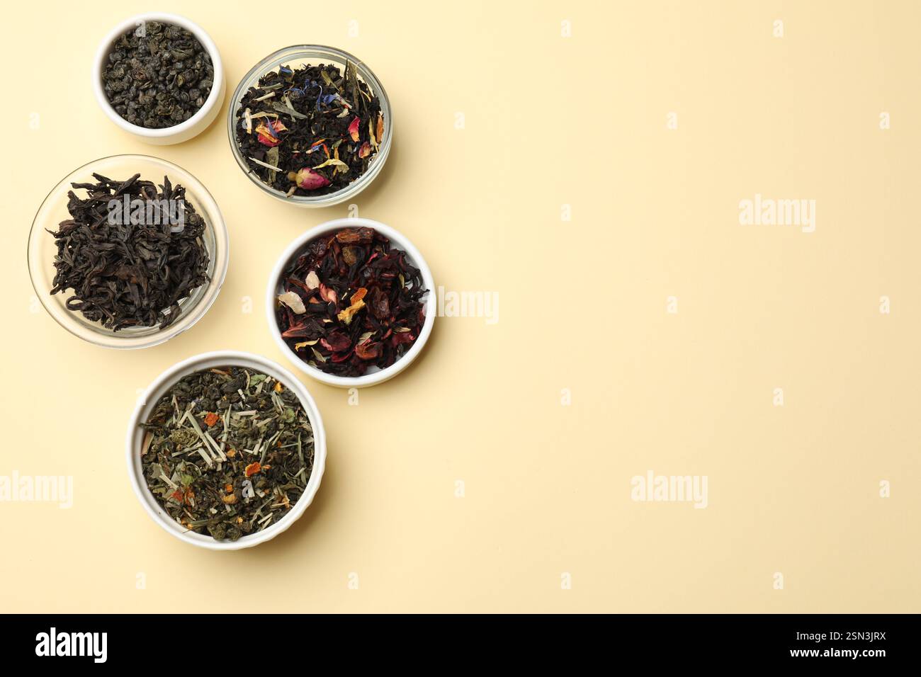 Different types of tea brew on beige background, flat lay. Space for ...