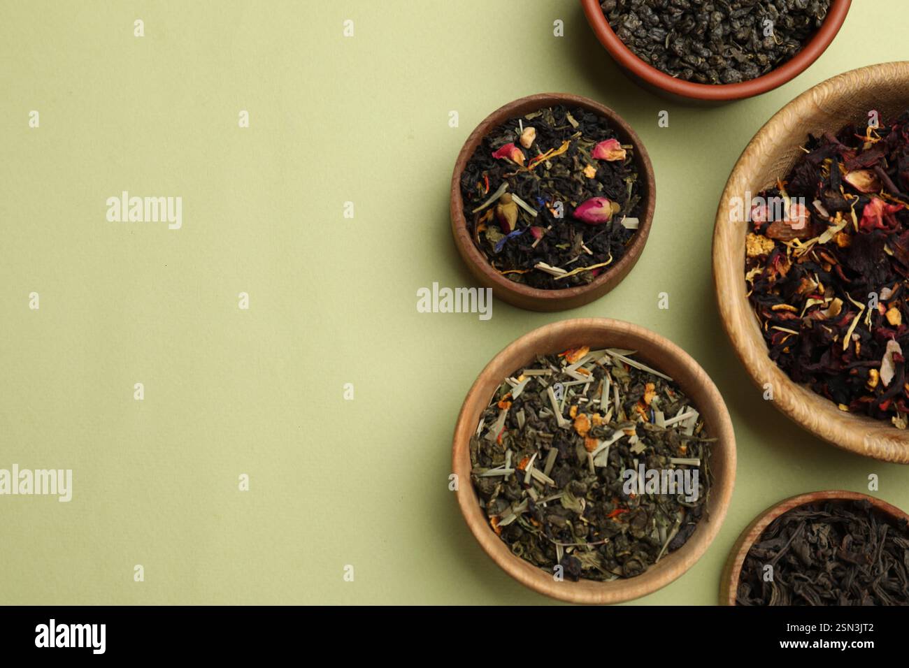 Different types of tea brew on olive background, flat lay. Space for ...