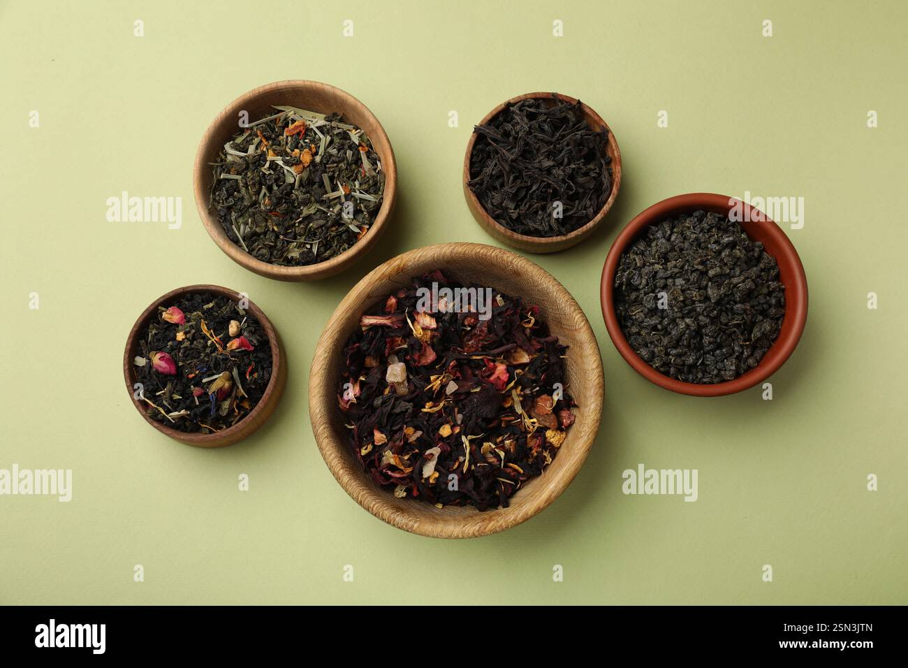 Different types of tea brew on olive background, flat lay Stock Photo ...