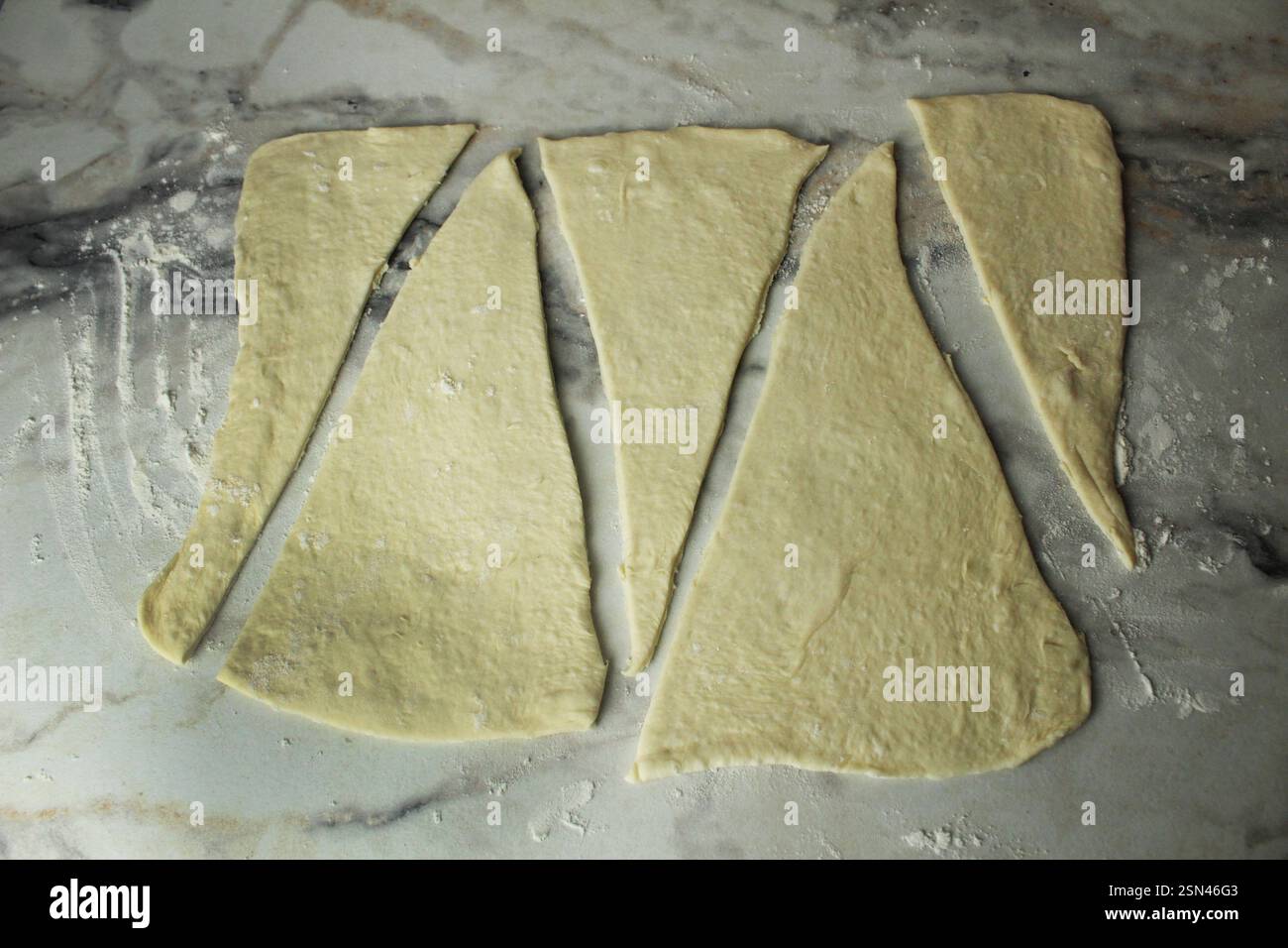 Puff pastry is cut into triangle pieces. Homemade cakes Stock Photo - Alamy