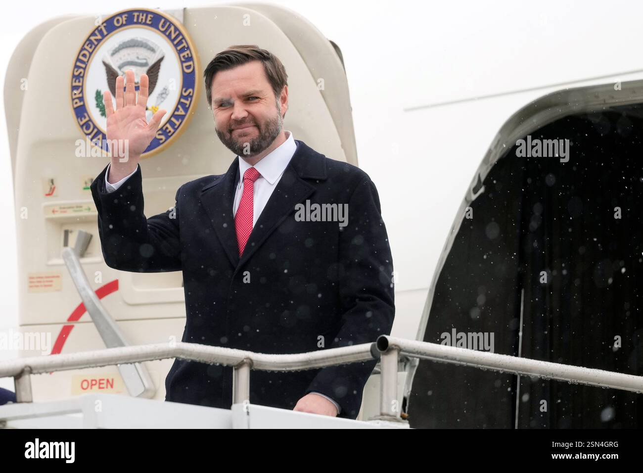 U.S. Vice President JD Vance waves as he arrives at the Munich airport ...