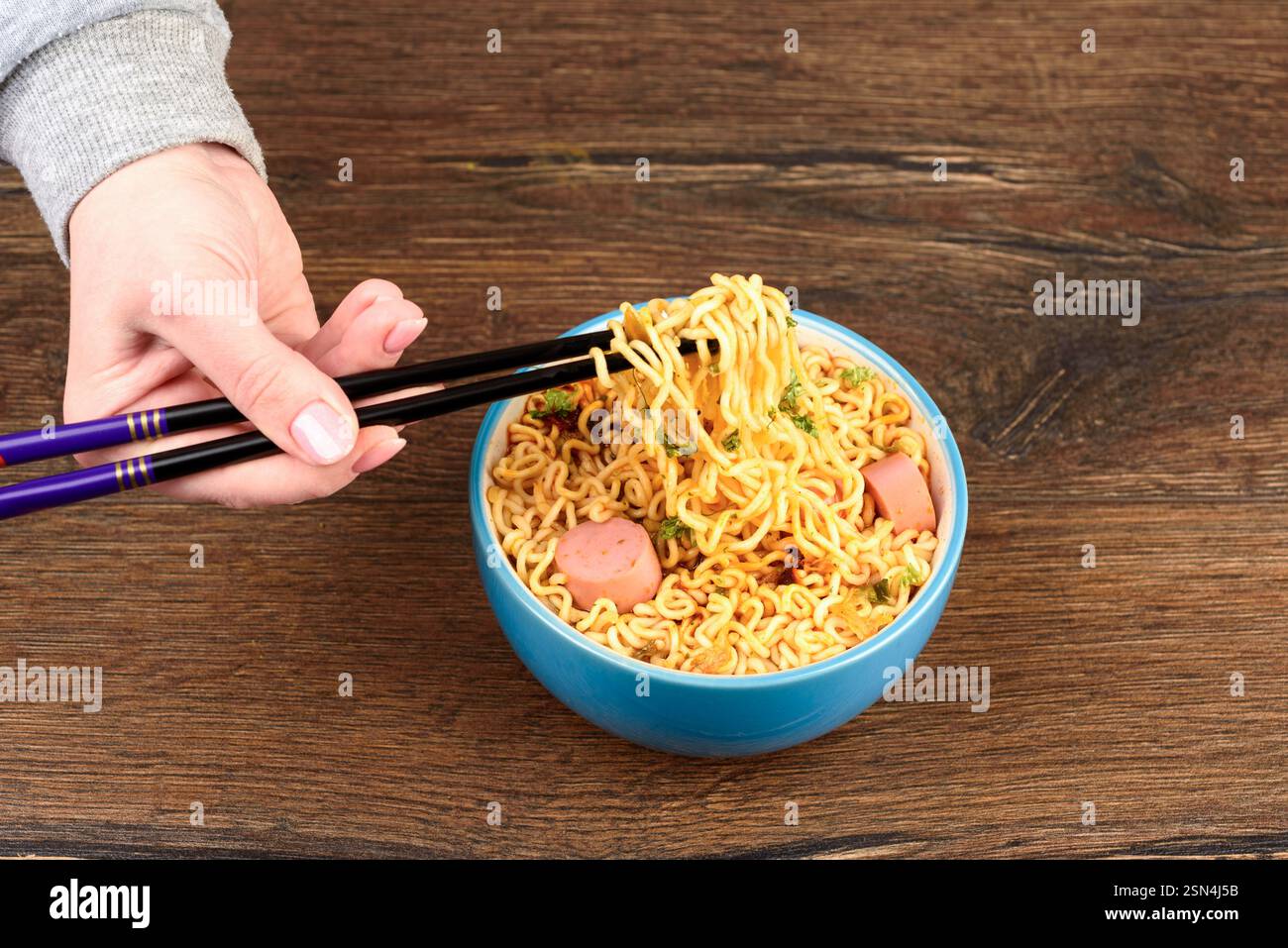 Woman eats instant noodle hi-res stock photography and images - Alamy