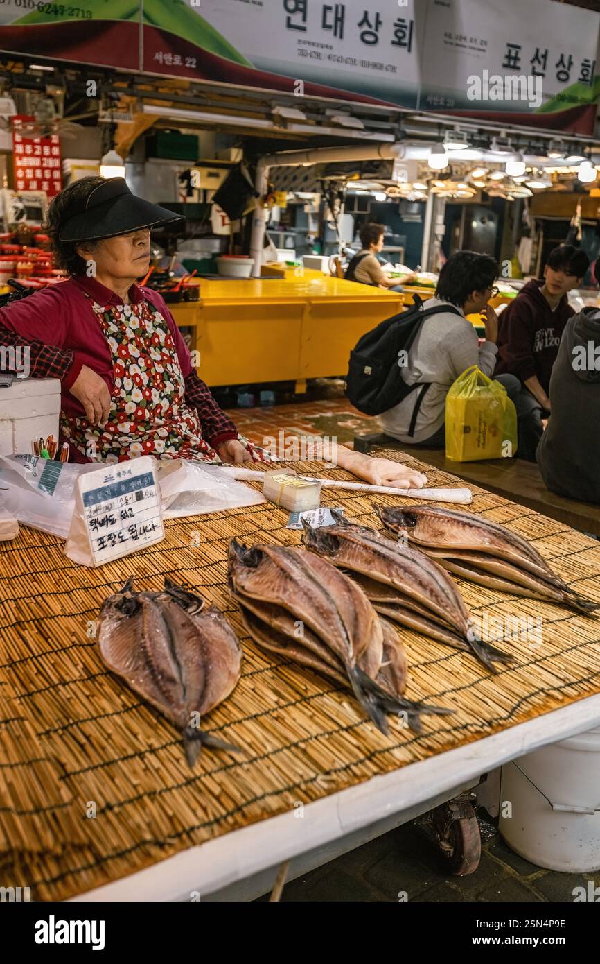 Korean woman selling fresh fish on the market in Jeju island South ...