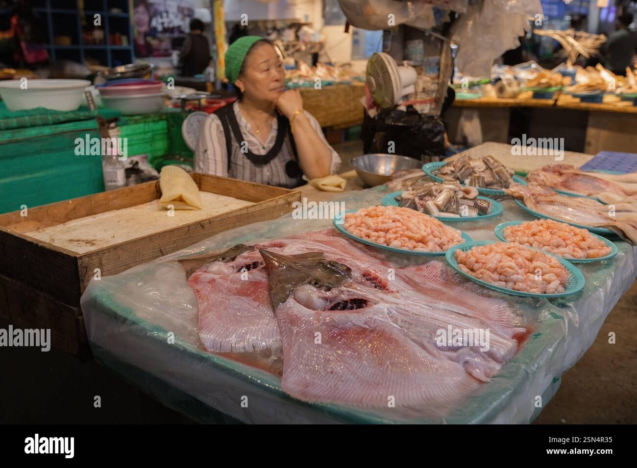 Korean woman selling fresh fish on the market in Jeju island South ...