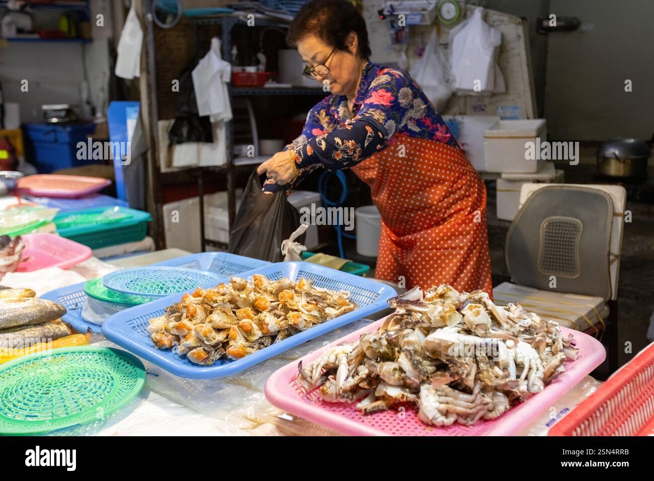 Korean woman selling fresh fish on the market in Jeju island South ...